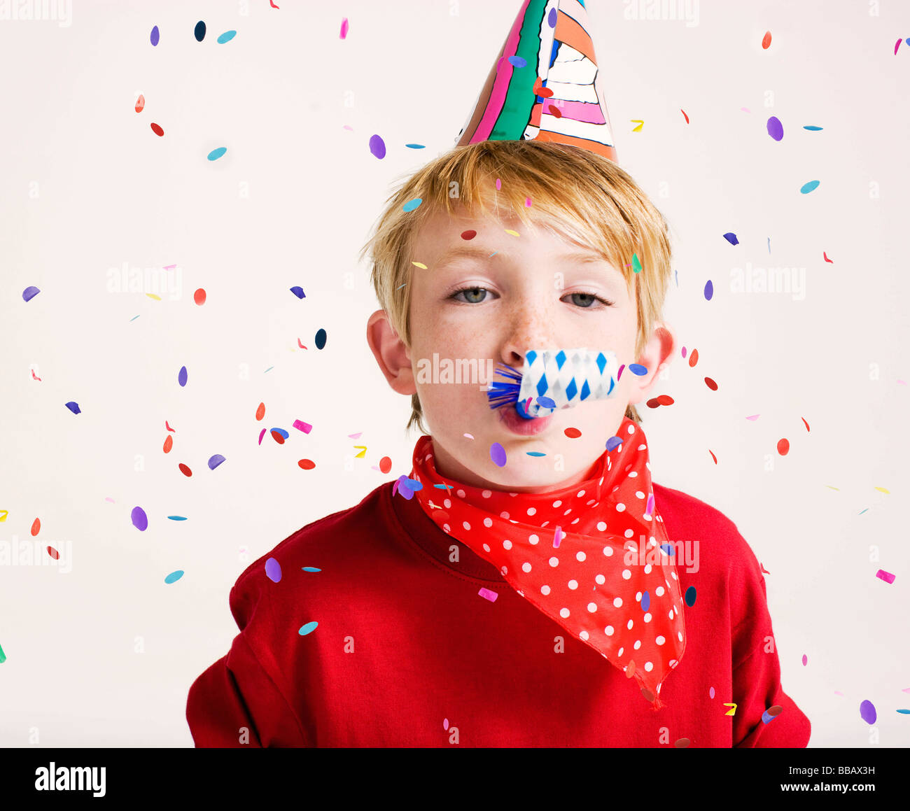 party boy blowing party blower Stock Photo - Alamy