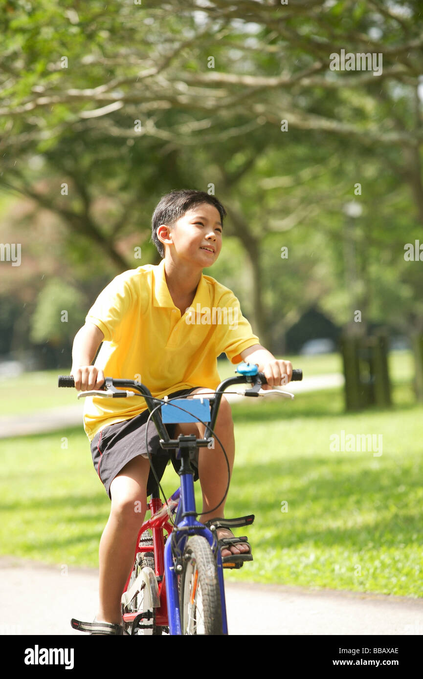 Boy in park, cycling Stock Photo - Alamy