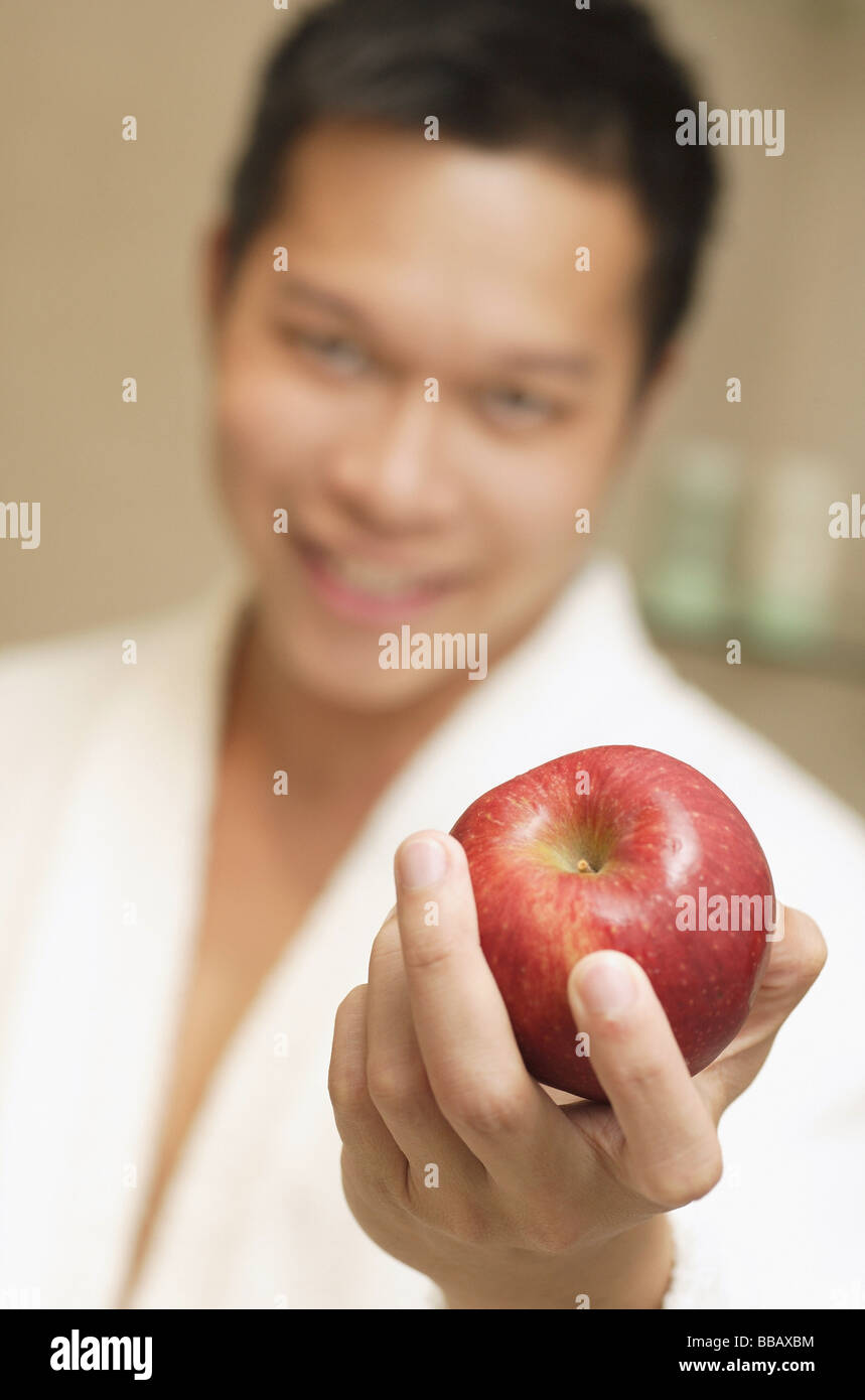 Young man holding apple Stock Photo - Alamy