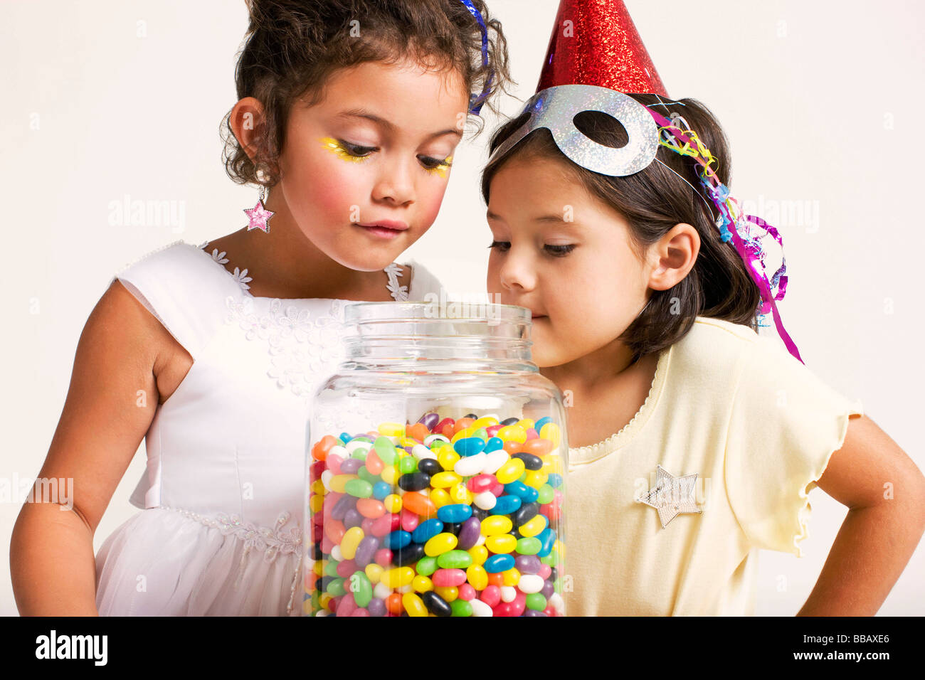 girls looking at sweet jar Stock Photo - Alamy