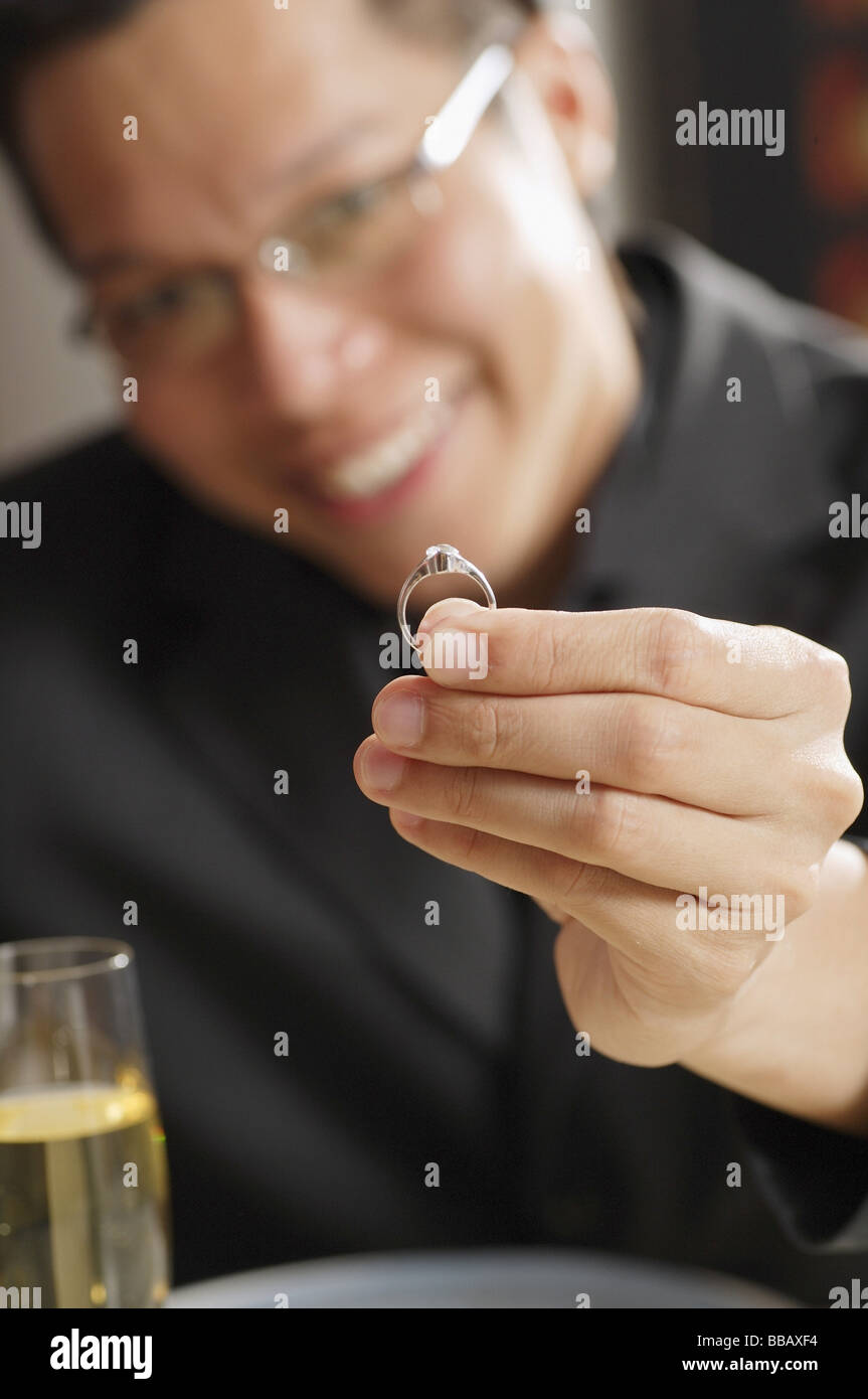 Man holding ring towards camera Stock Photo - Alamy