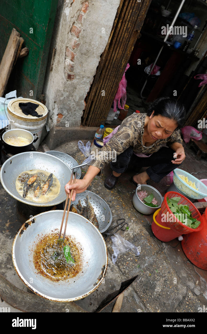 vietnamese lady cooking deep fried fish and spring roll, Hanoi, vietnam ...