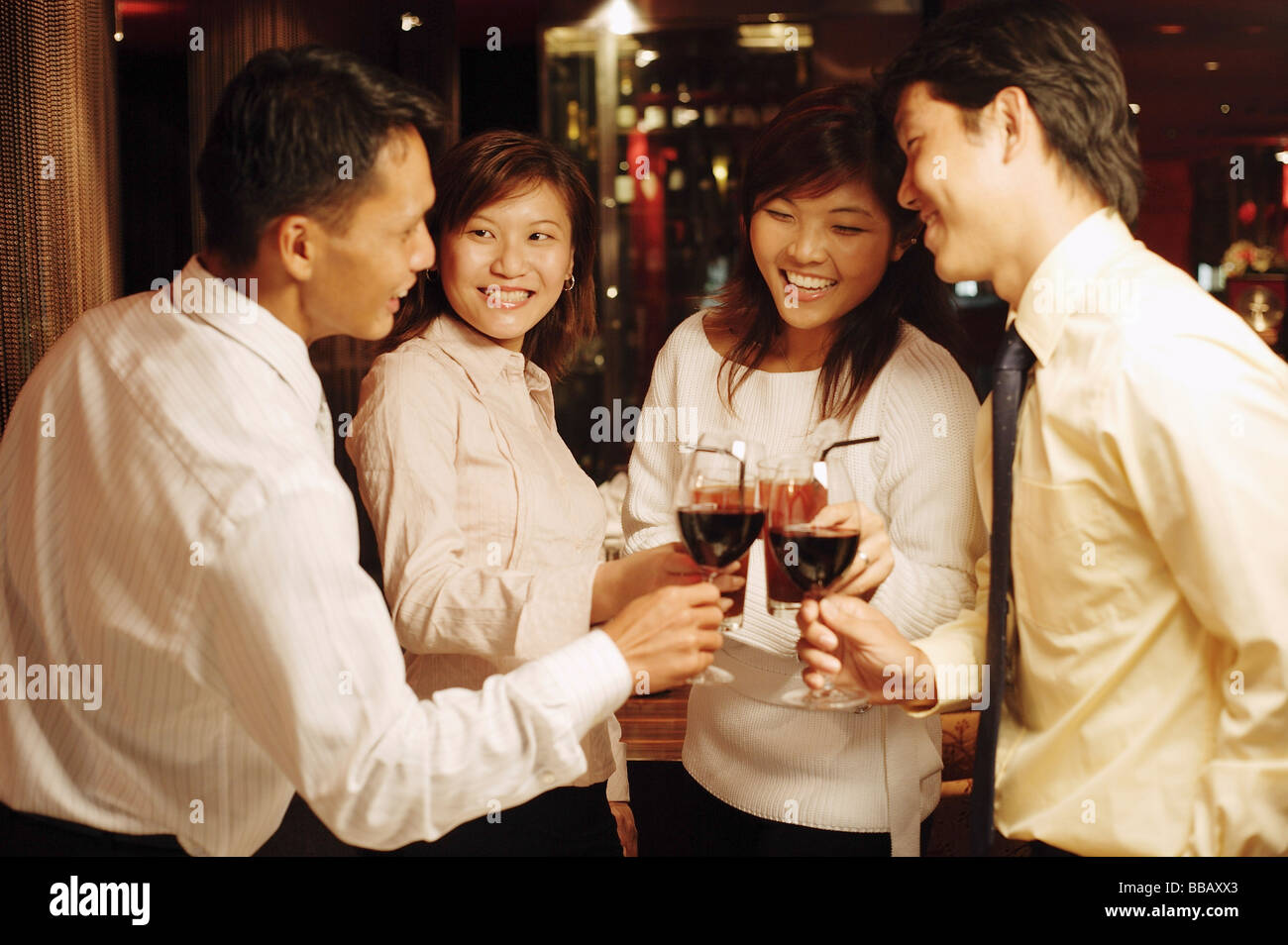 Young executives standing, toasting with wine Stock Photo - Alamy