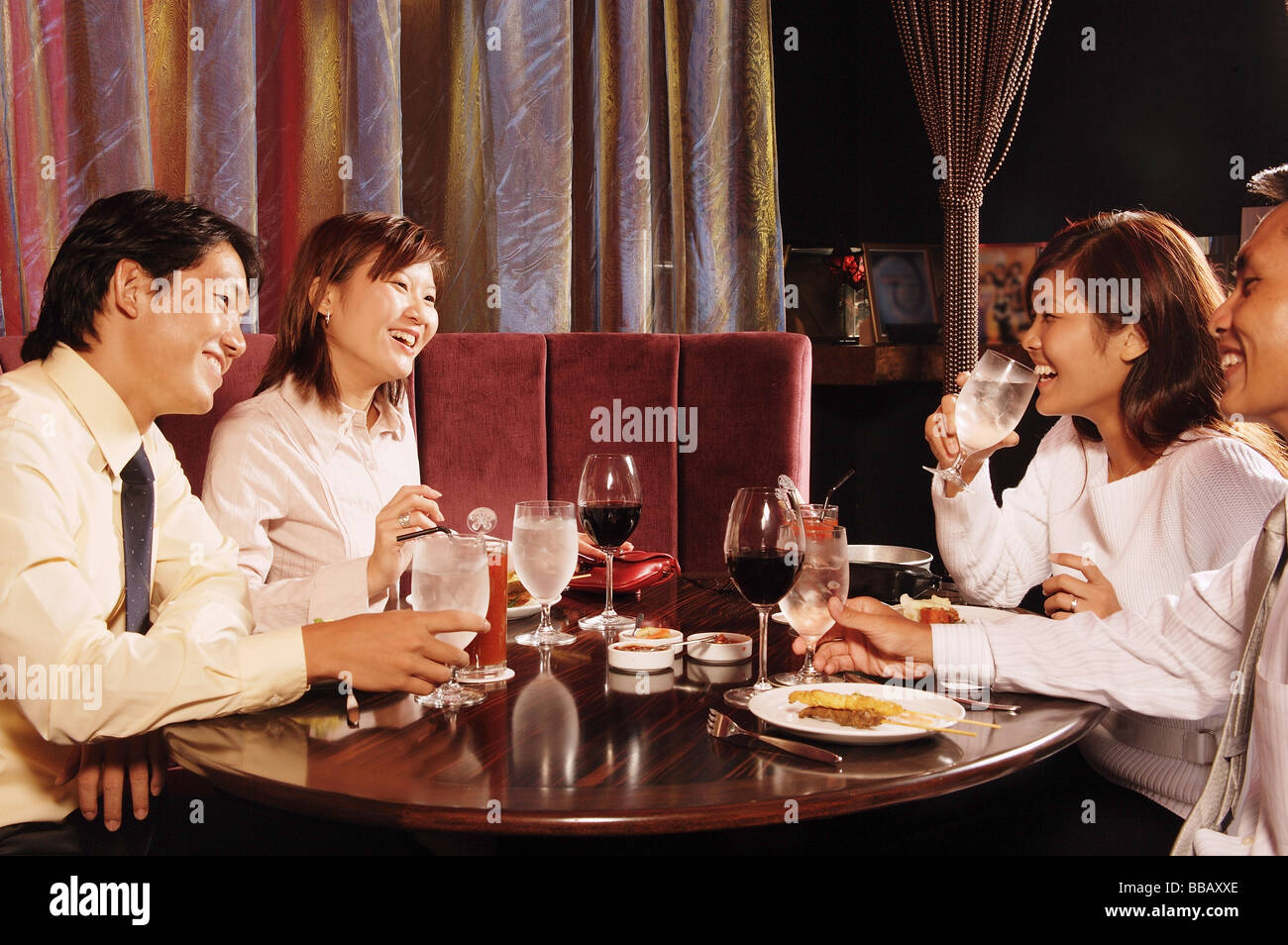 Couples sitting at restaurant, having dinner Stock Photo - Alamy