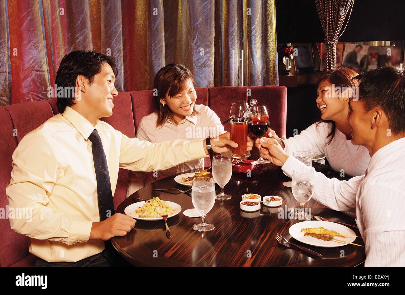 Toasting across table hi-res stock photography and images - Alamy