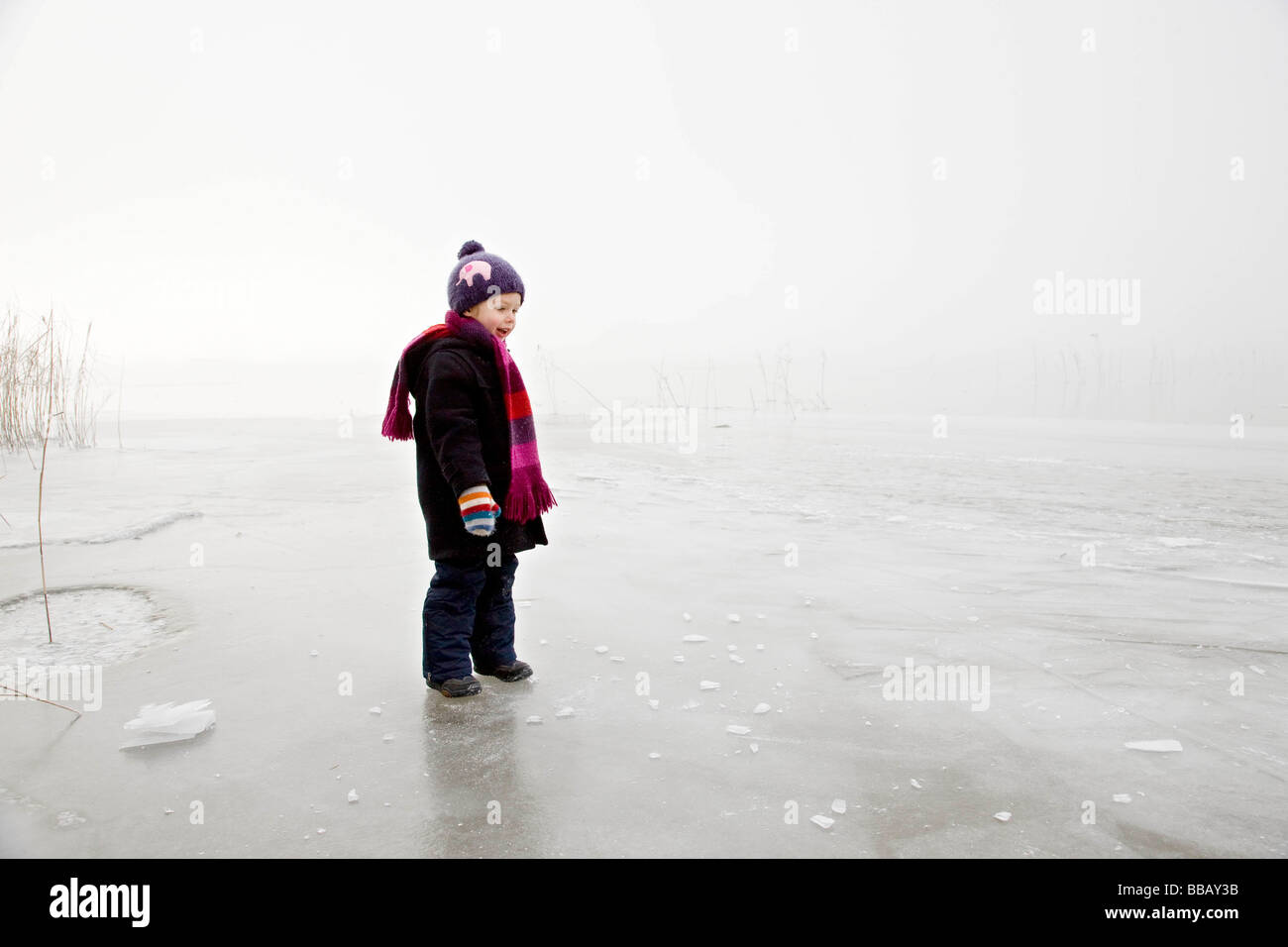 boy on frozen lake in the fog Stock Photo - Alamy