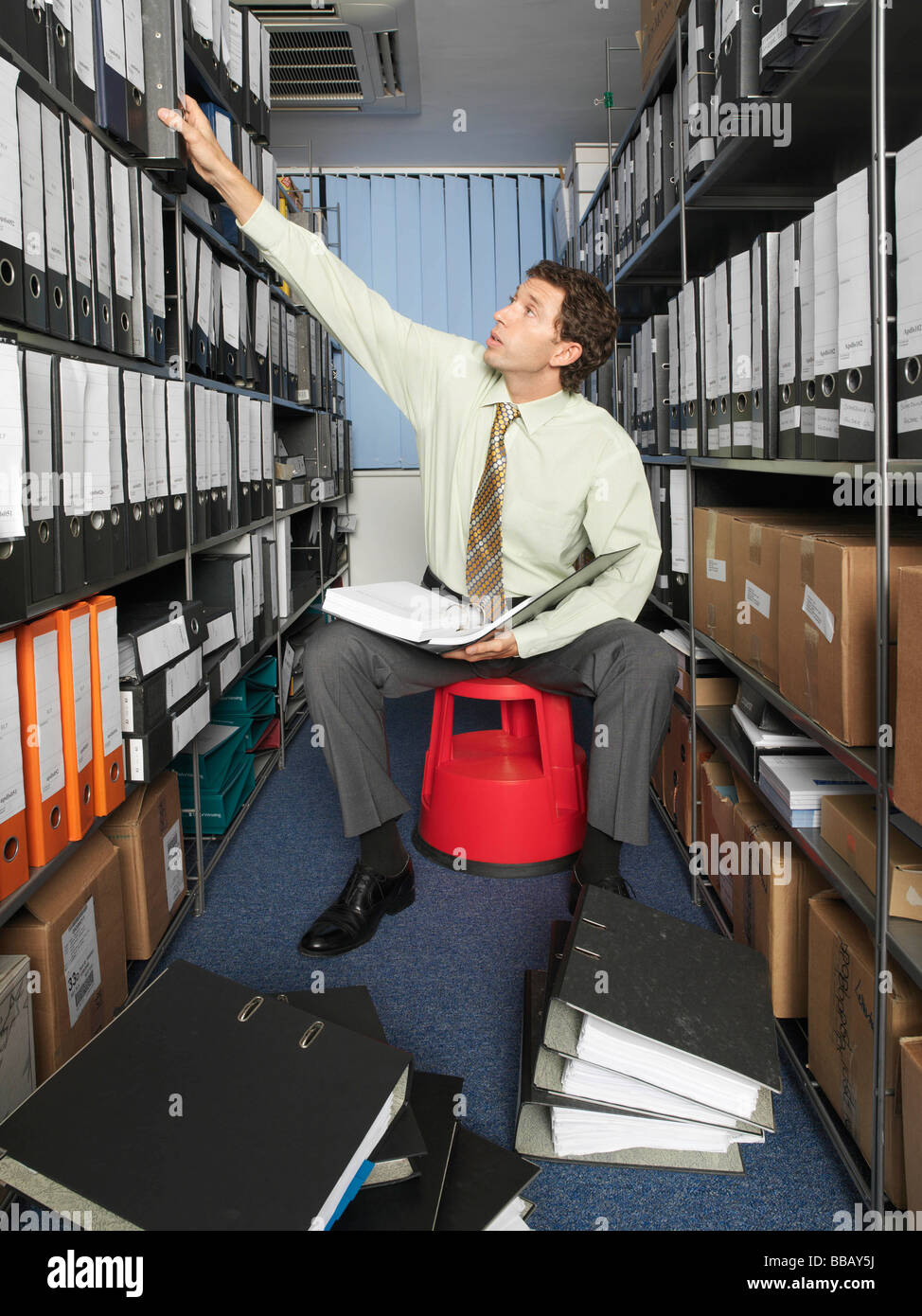 Office worker surrounded by files Stock Photo - Alamy