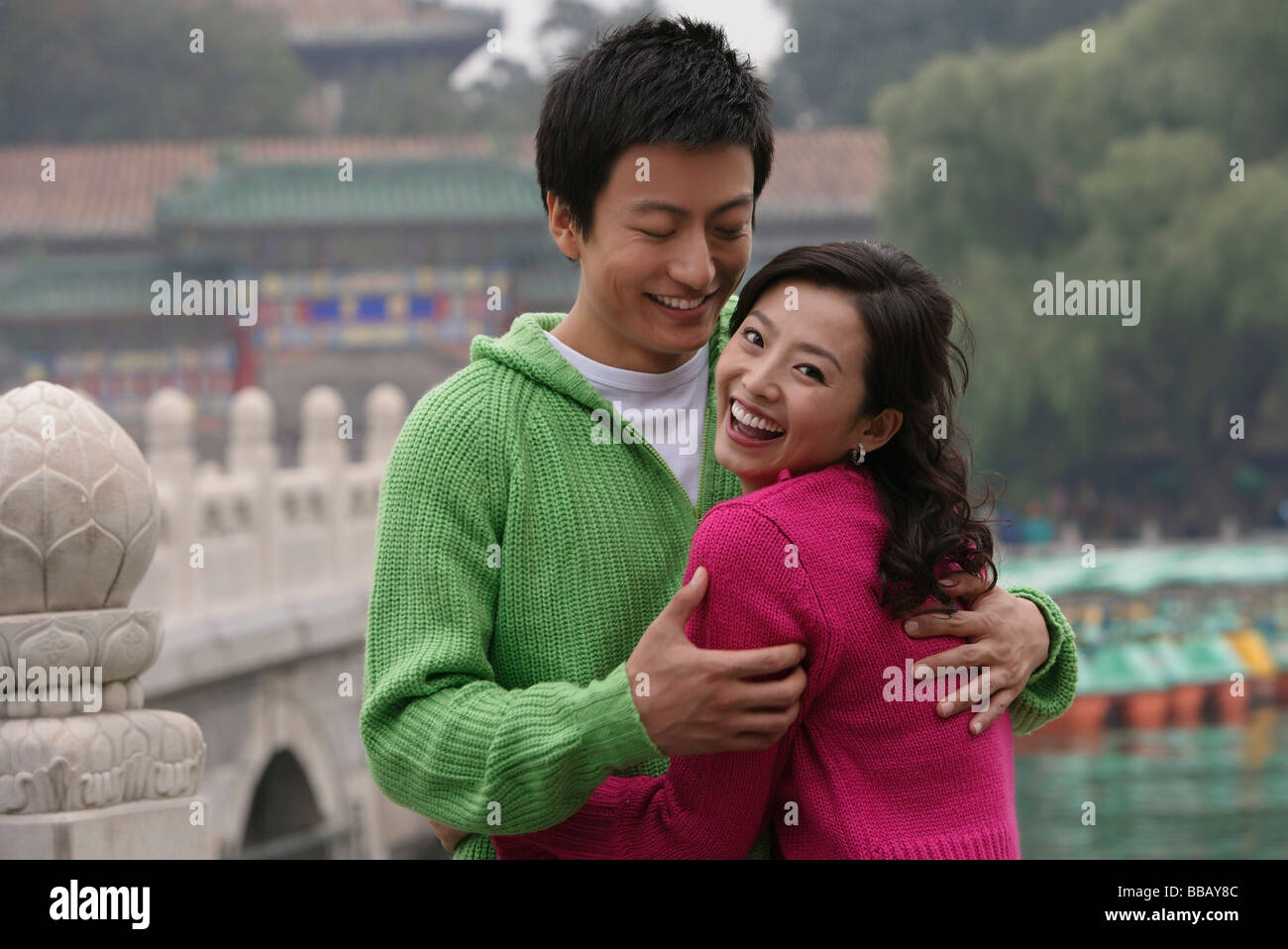 A couple smile as they hug Stock Photo - Alamy