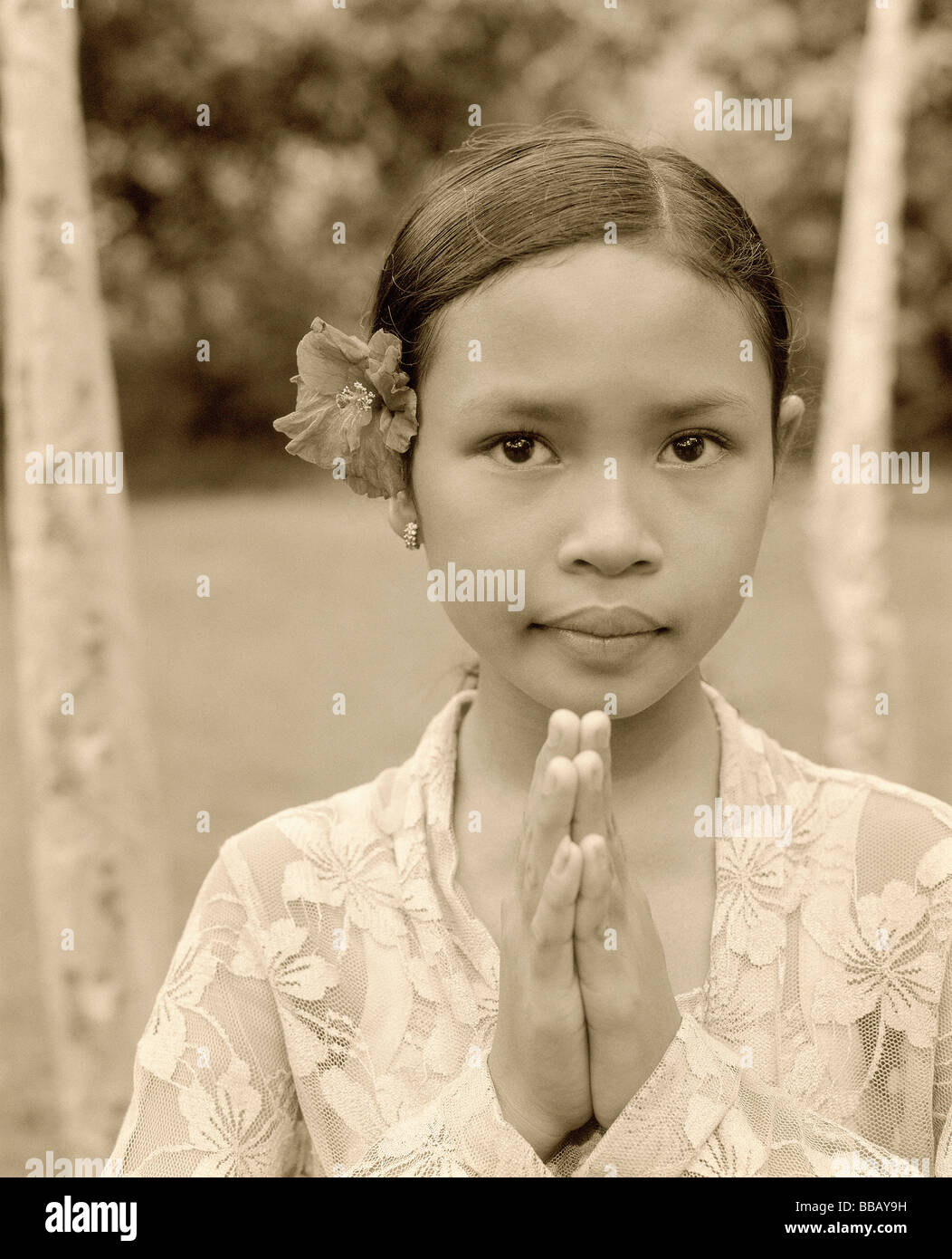 Indonesia, Bali, young girl with flower behind ear, traditional ...