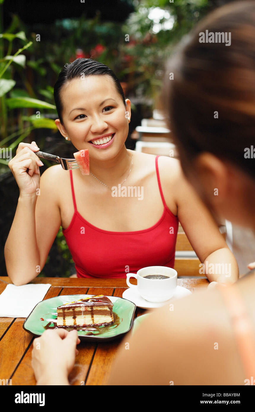 Women at cafe, eating, over the shoulder view Stock Photo - Alamy
