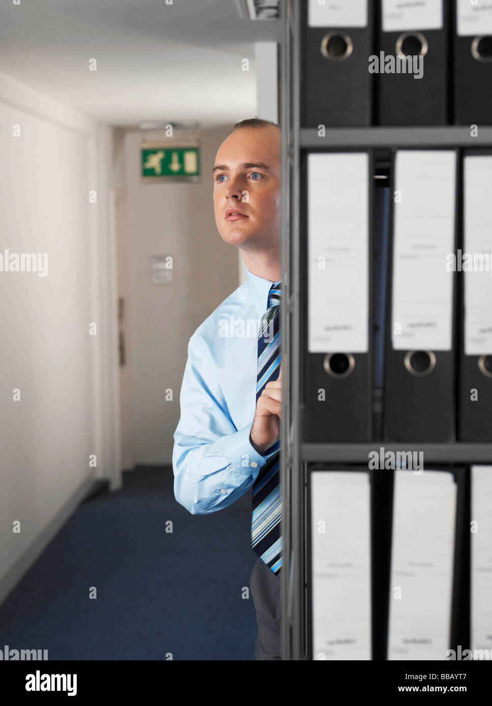 Office worker hiding behind files Stock Photo - Alamy