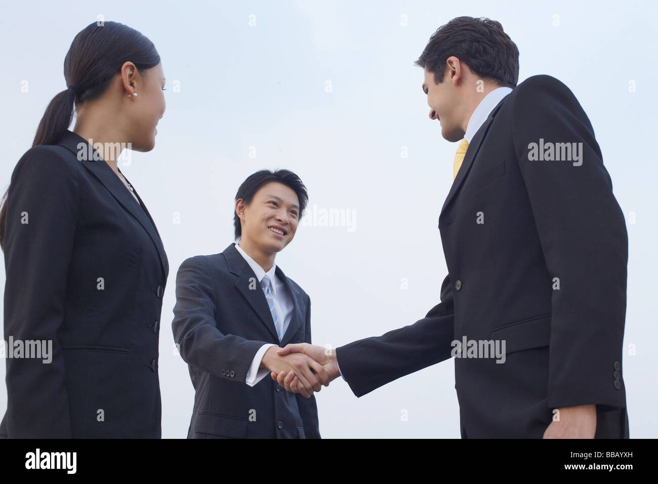 Businesspeople shaking hands, low angle view Stock Photo - Alamy