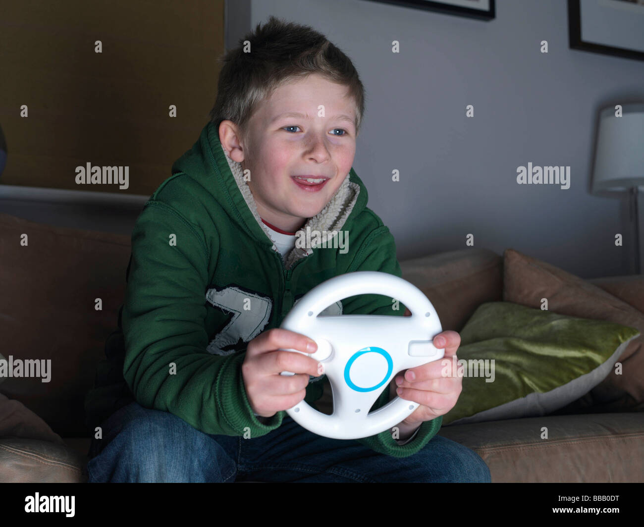 Boy, 11 playing driving game Stock Photo - Alamy