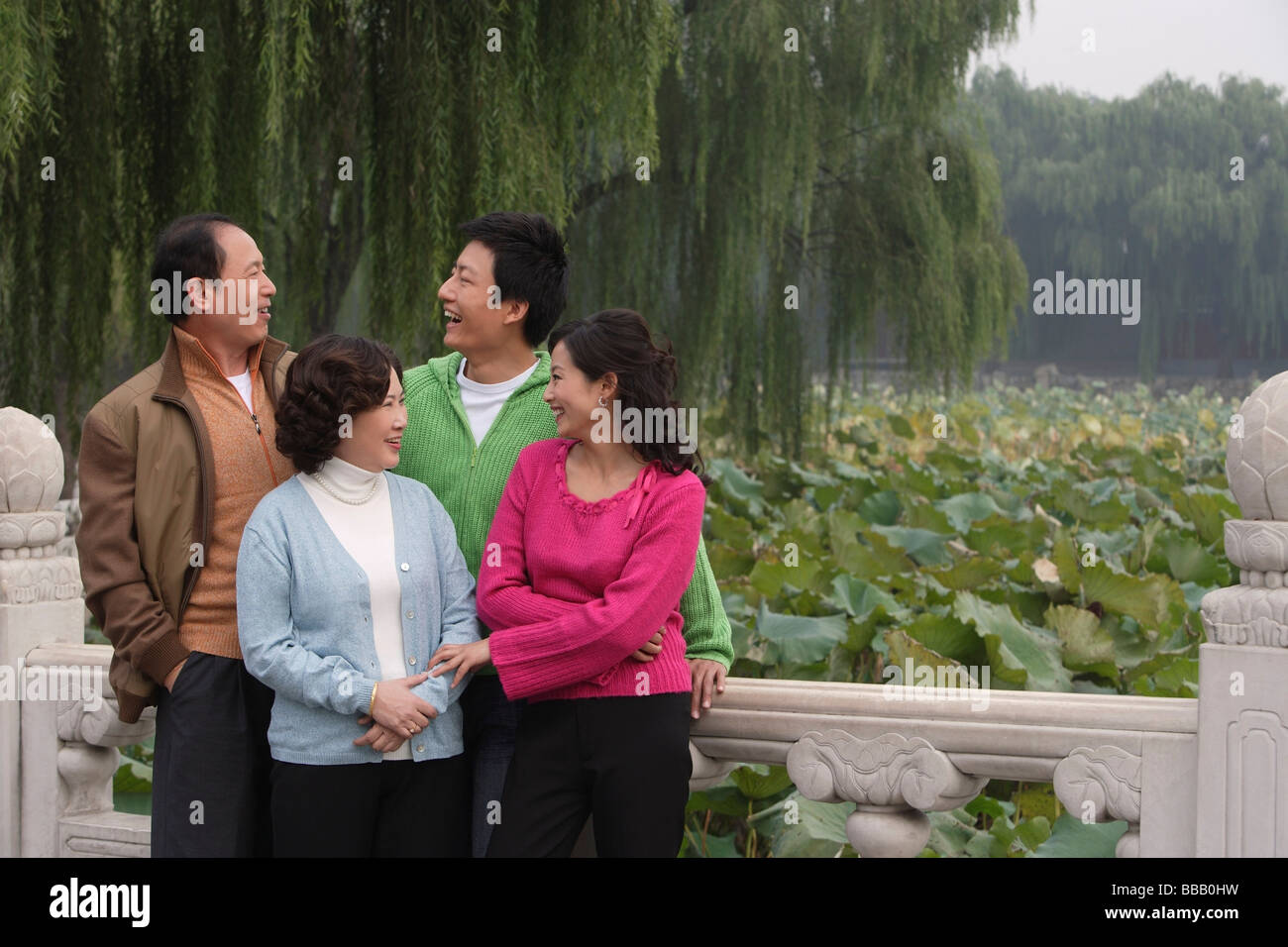 A family stand together on a bridge Stock Photo - Alamy