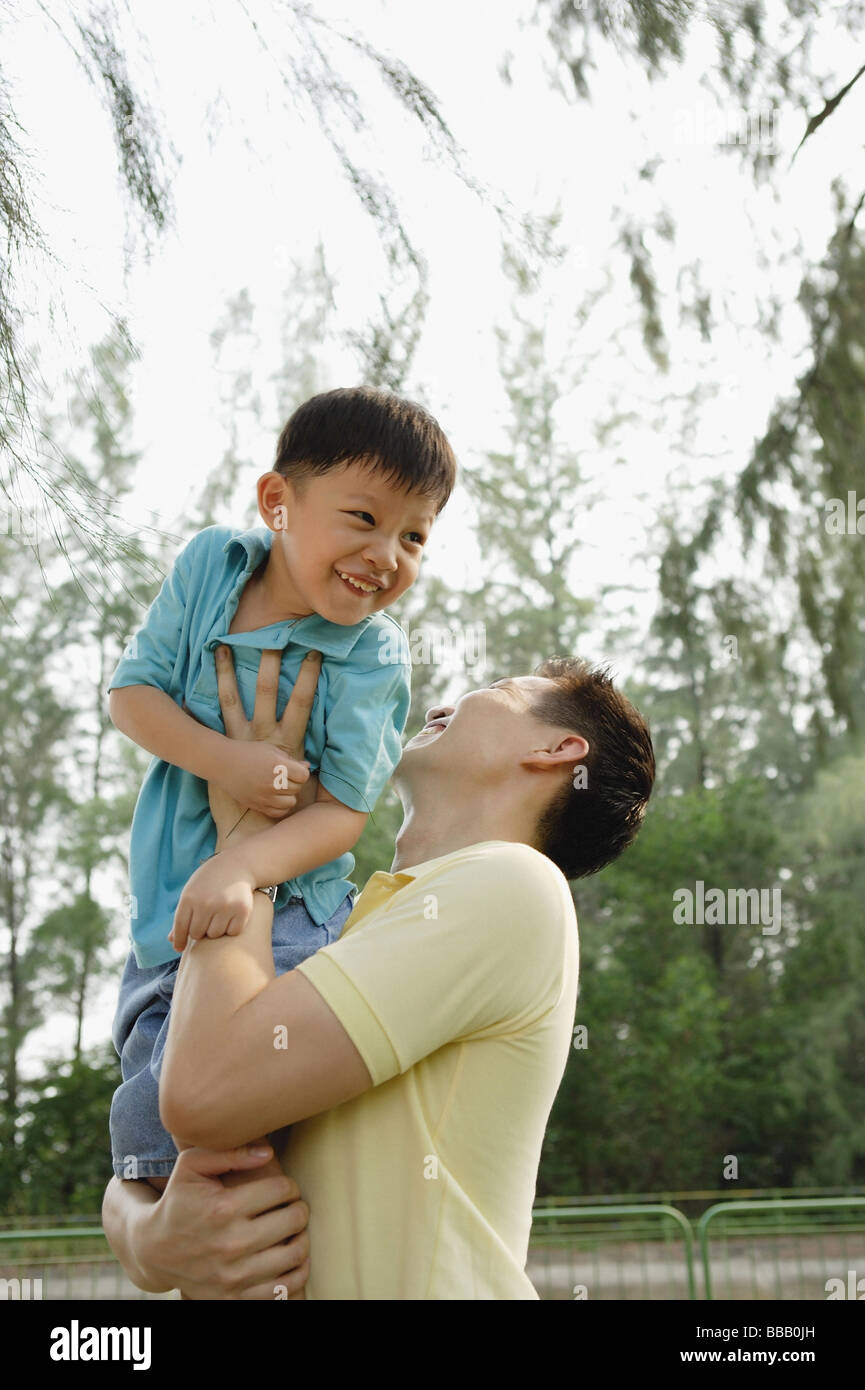 Father lifting son Stock Photo - Alamy