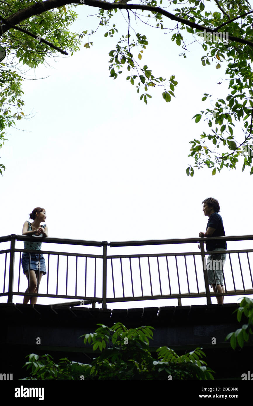 Couple standing apart, looking at each other Stock Photo - Alamy
