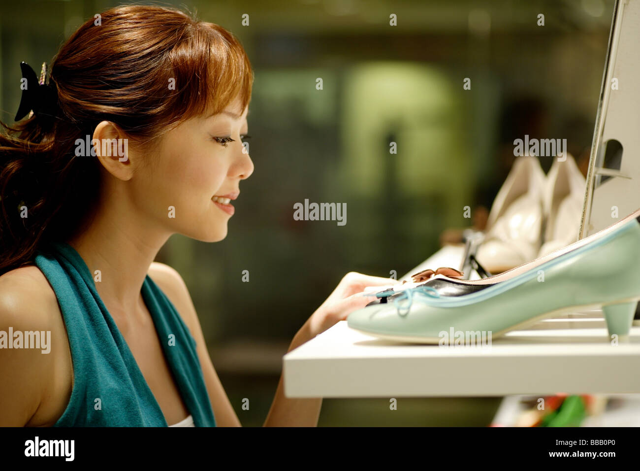 Woman looking at shoes in shoe store Stock Photo - Alamy