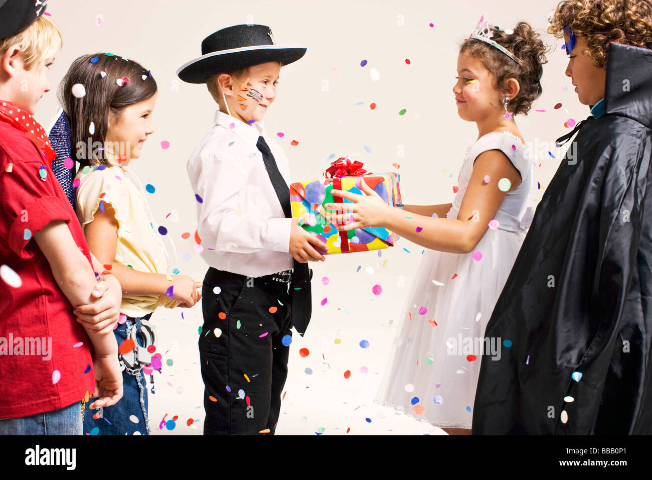 child handing over present in party Stock Photo - Alamy