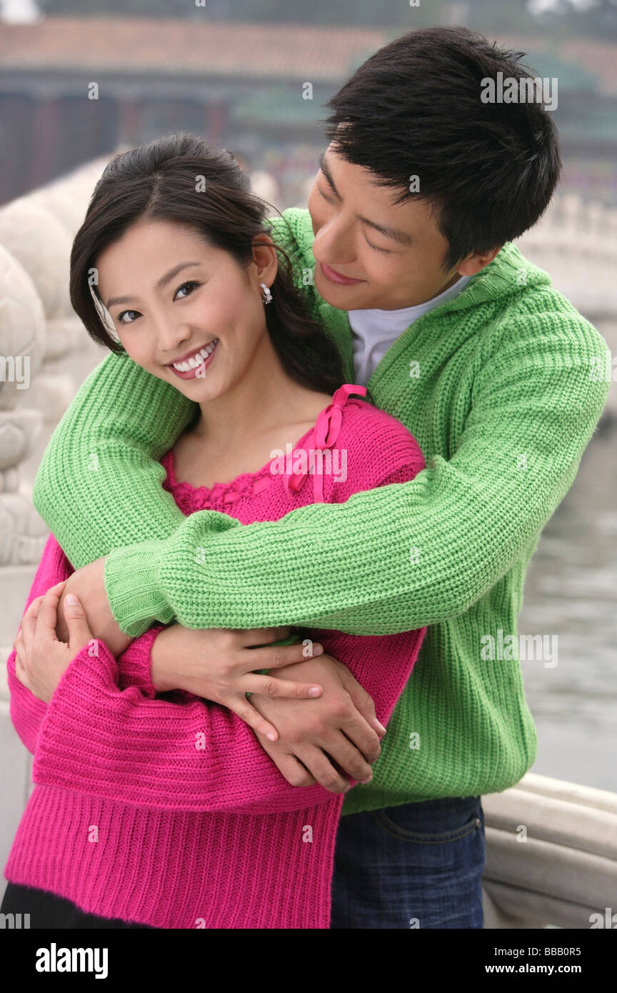 Chinese couple smile and hug Stock Photo - Alamy