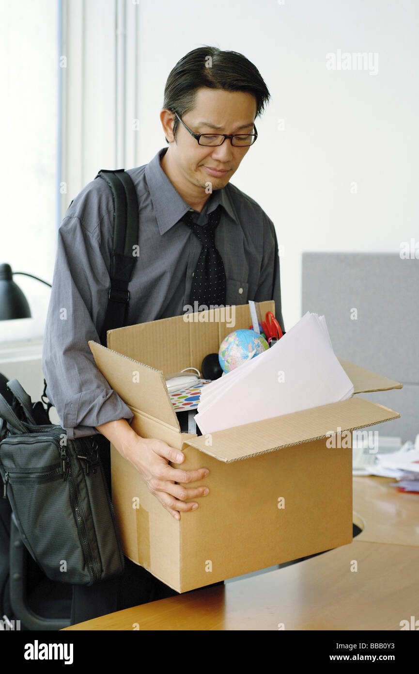Businessman in office carrying box hi-res stock photography and images ...