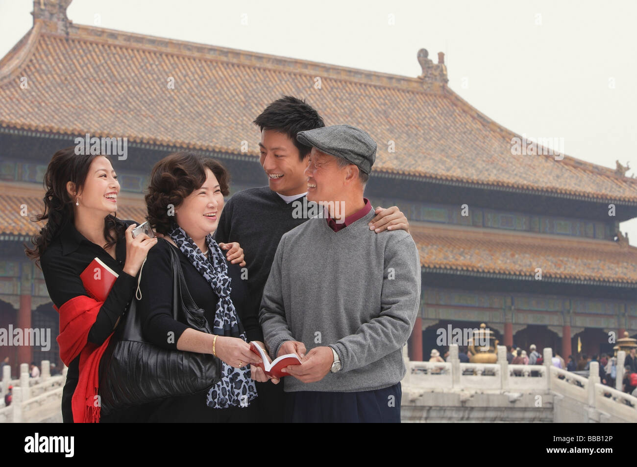 A family pose for photos together in front of The Forbidden City ...