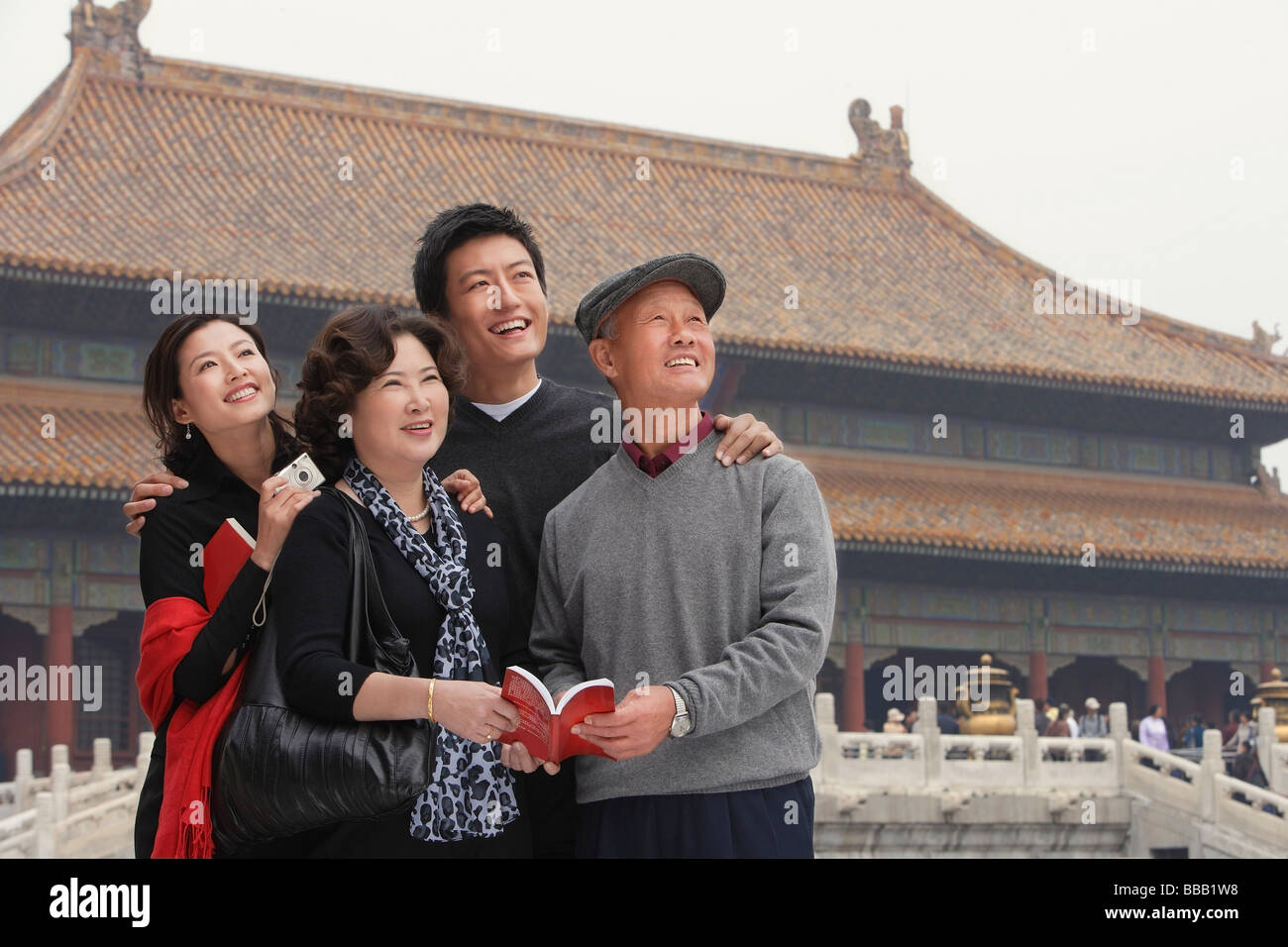 A family pose for photos together in front of The Forbidden City ...