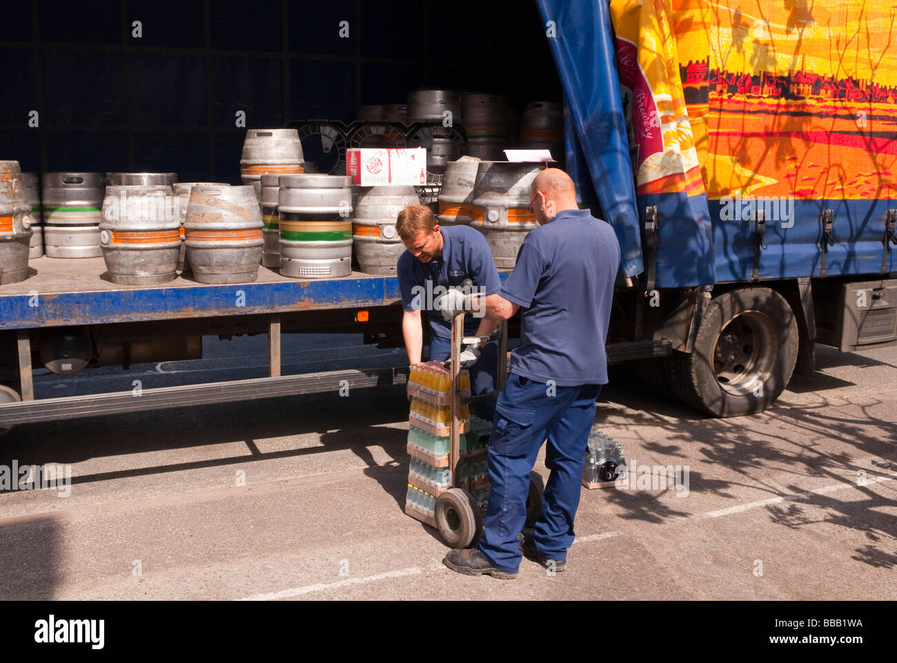 Two Adnams brewery staff workers unloading and delivering ale and beer ...