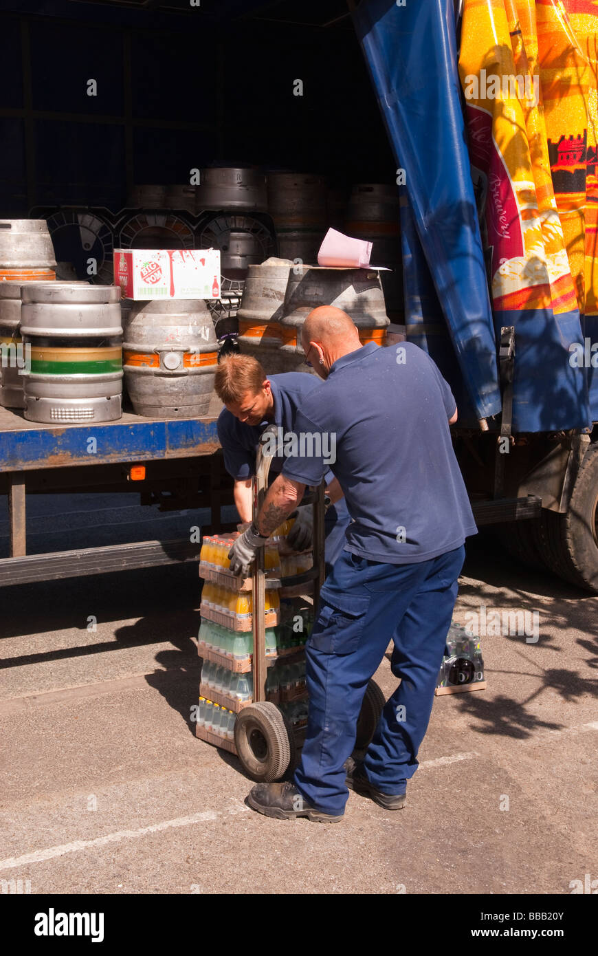Two Adnams brewery staff workers unloading and delivering ale and beer ...