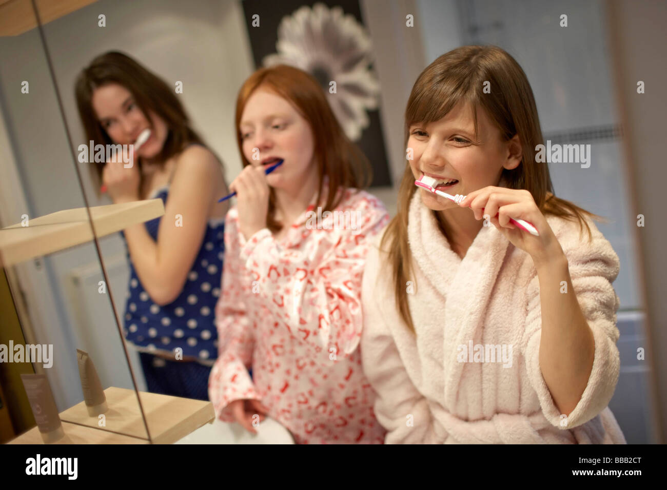 Teenage girls brushing teeth Stock Photo - Alamy