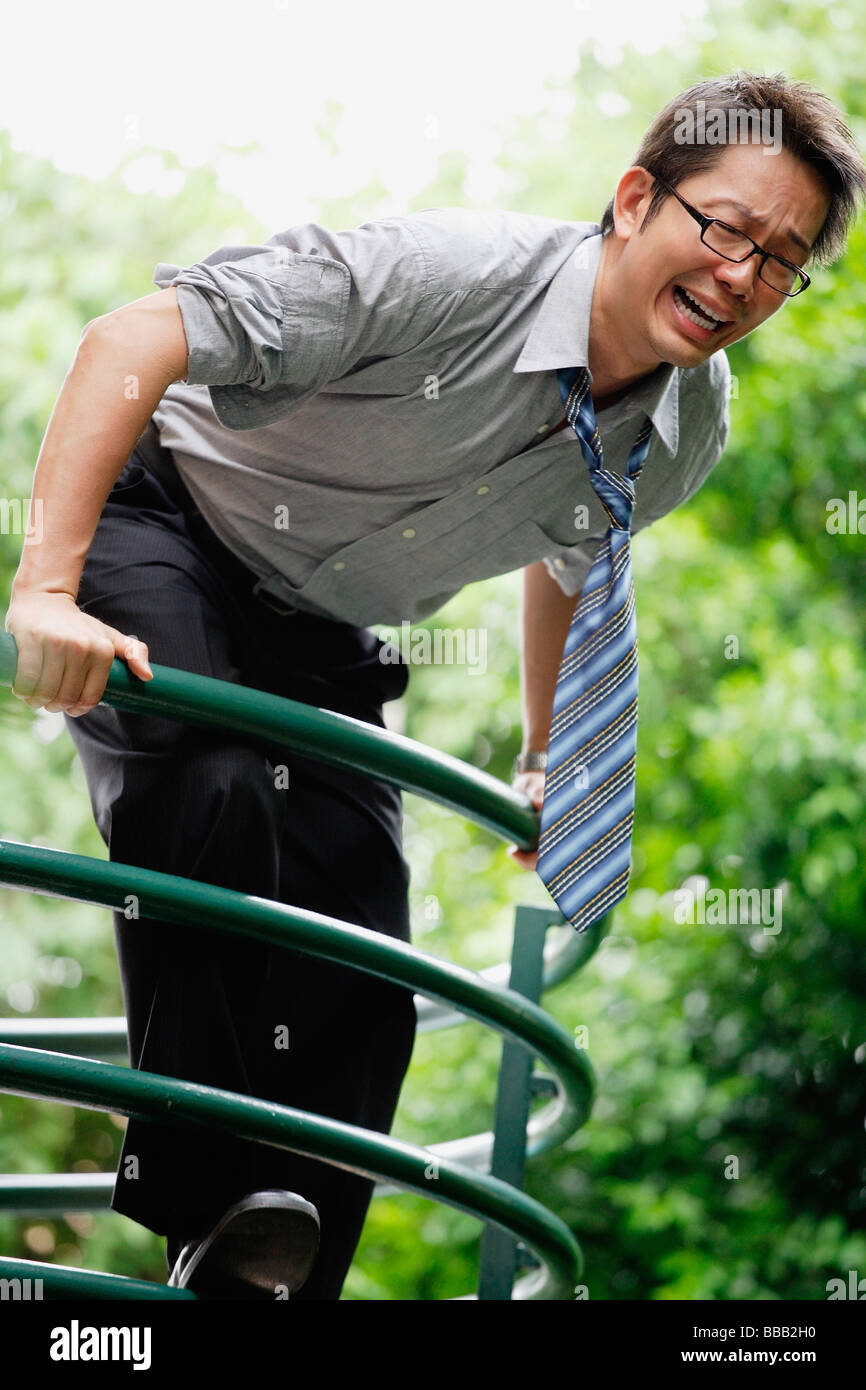 A man looks stressed as he leans over a railing Stock Photo - Alamy