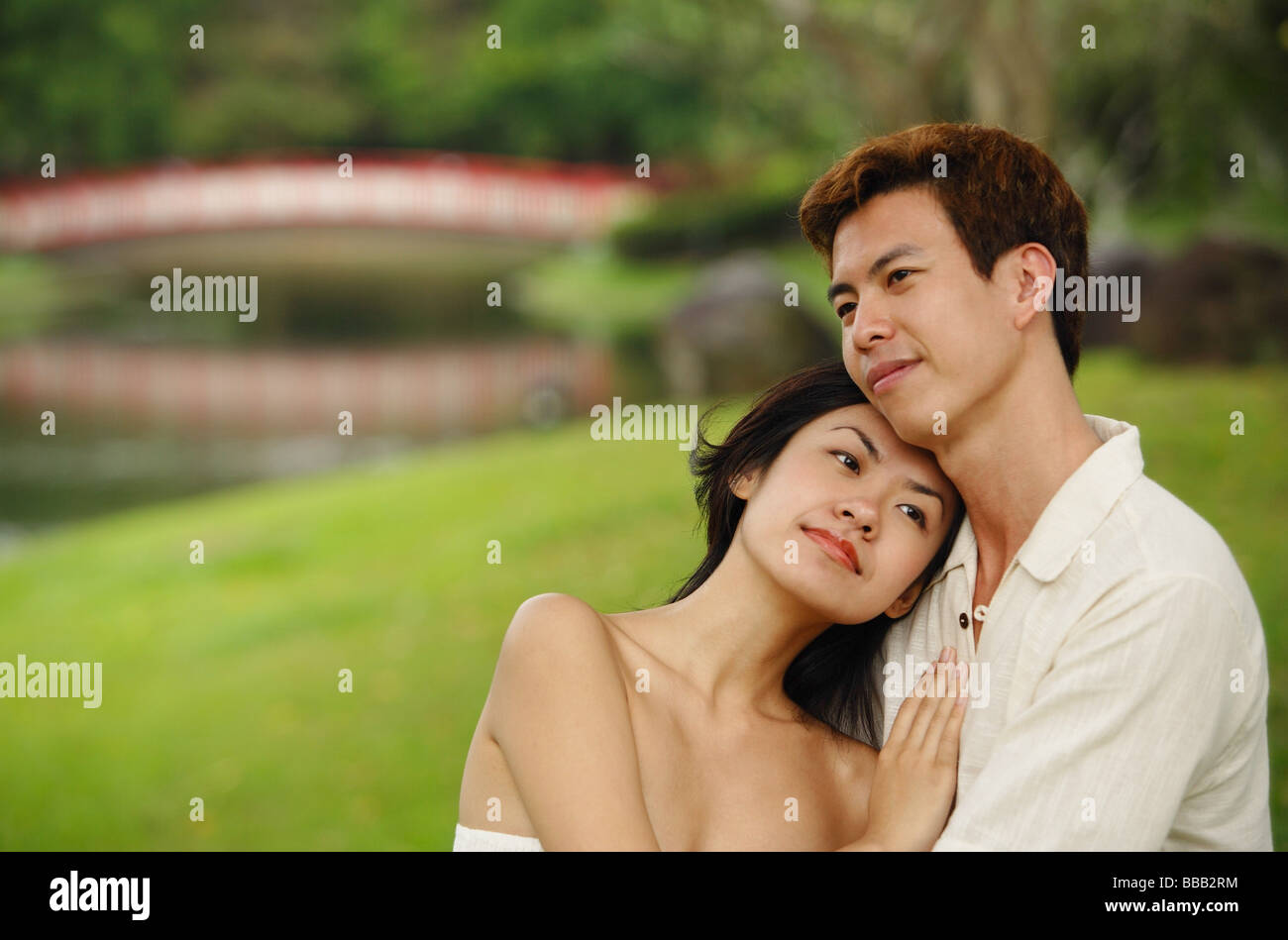 Couple embracing, woman leaning on mans chest Stock Photo - Alamy