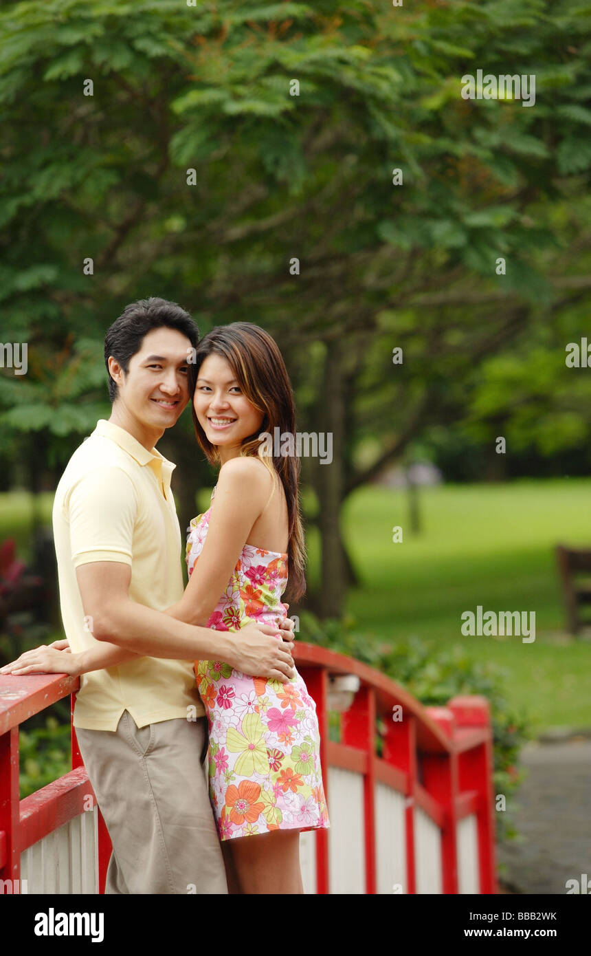 Couple standing cheek to cheek, smiling at camera Stock Photo - Alamy