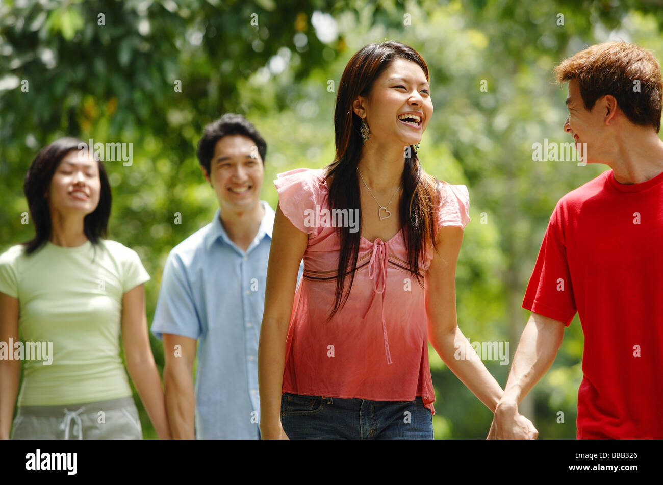Couples walking, holding hands Stock Photo - Alamy