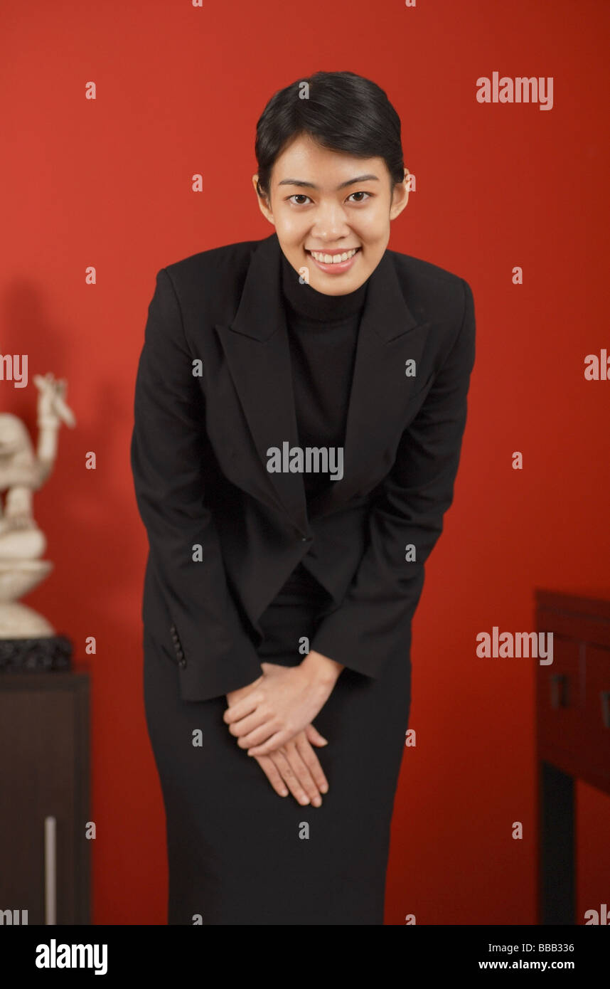 Female executive smiling and bowing Stock Photo - Alamy