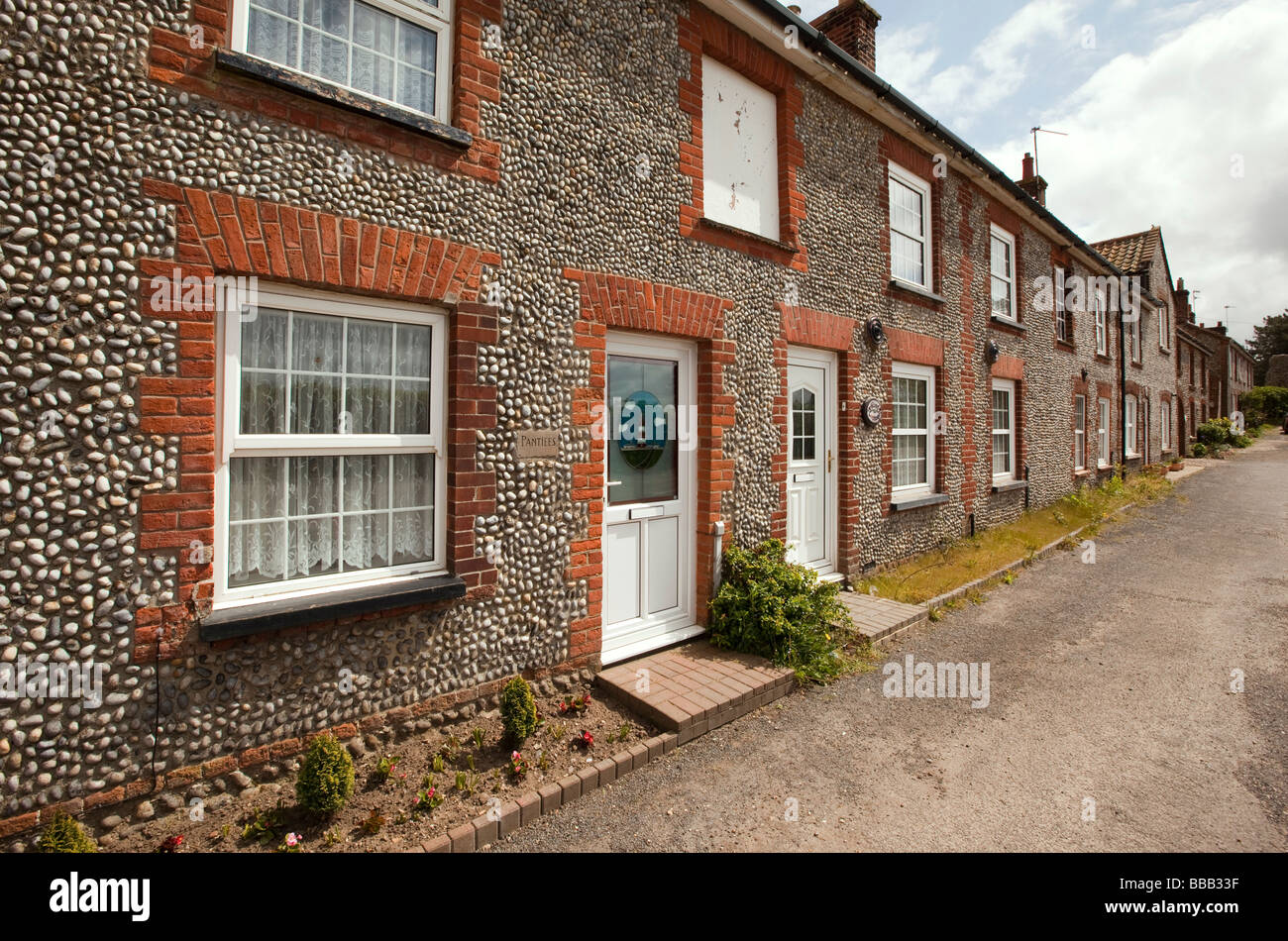 UK England Norfolk Bacton Broomholm Priory Road terrace of flint pebble ...