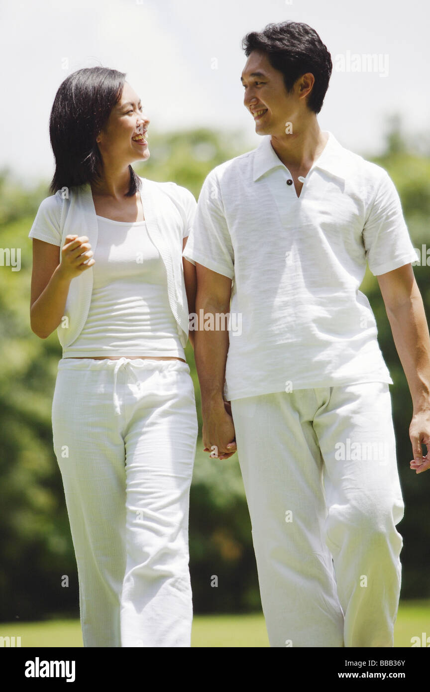 Couple walking hand in hand Stock Photo - Alamy