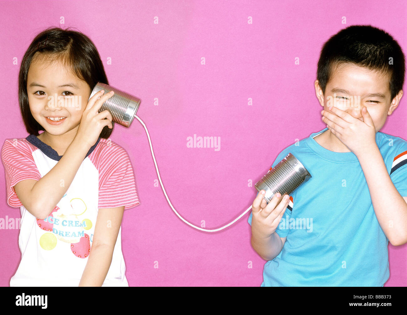 Children playing with toy string telephone, purple background Stock ...