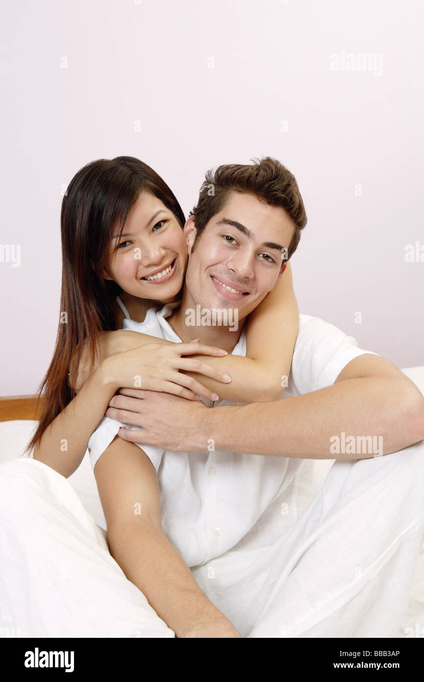 Couple embracing, woman hugging man from behind Stock Photo - Alamy