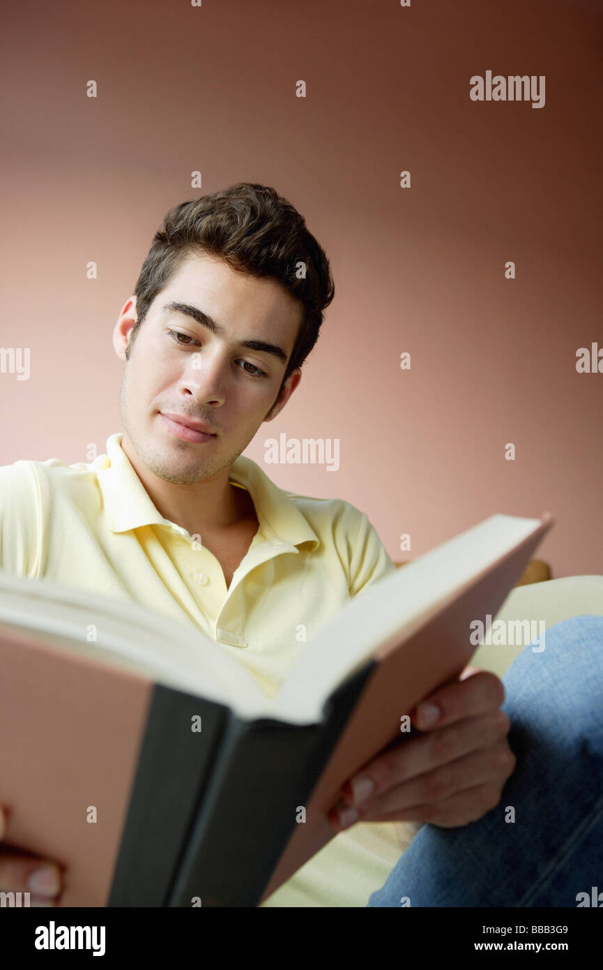 Man sitting and reading book Stock Photo - Alamy