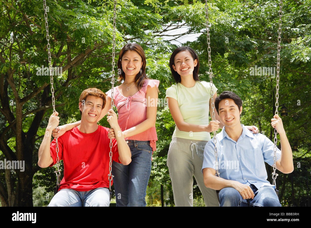 Smiling young couple swings on hi-res stock photography and images - Alamy