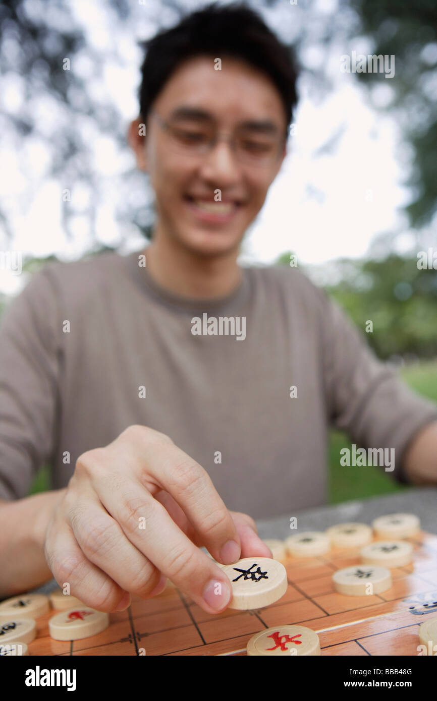 Man making move in Chinese chess game Stock Photo - Alamy