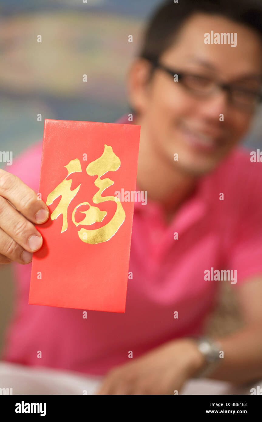 Man holding red packet Stock Photo - Alamy