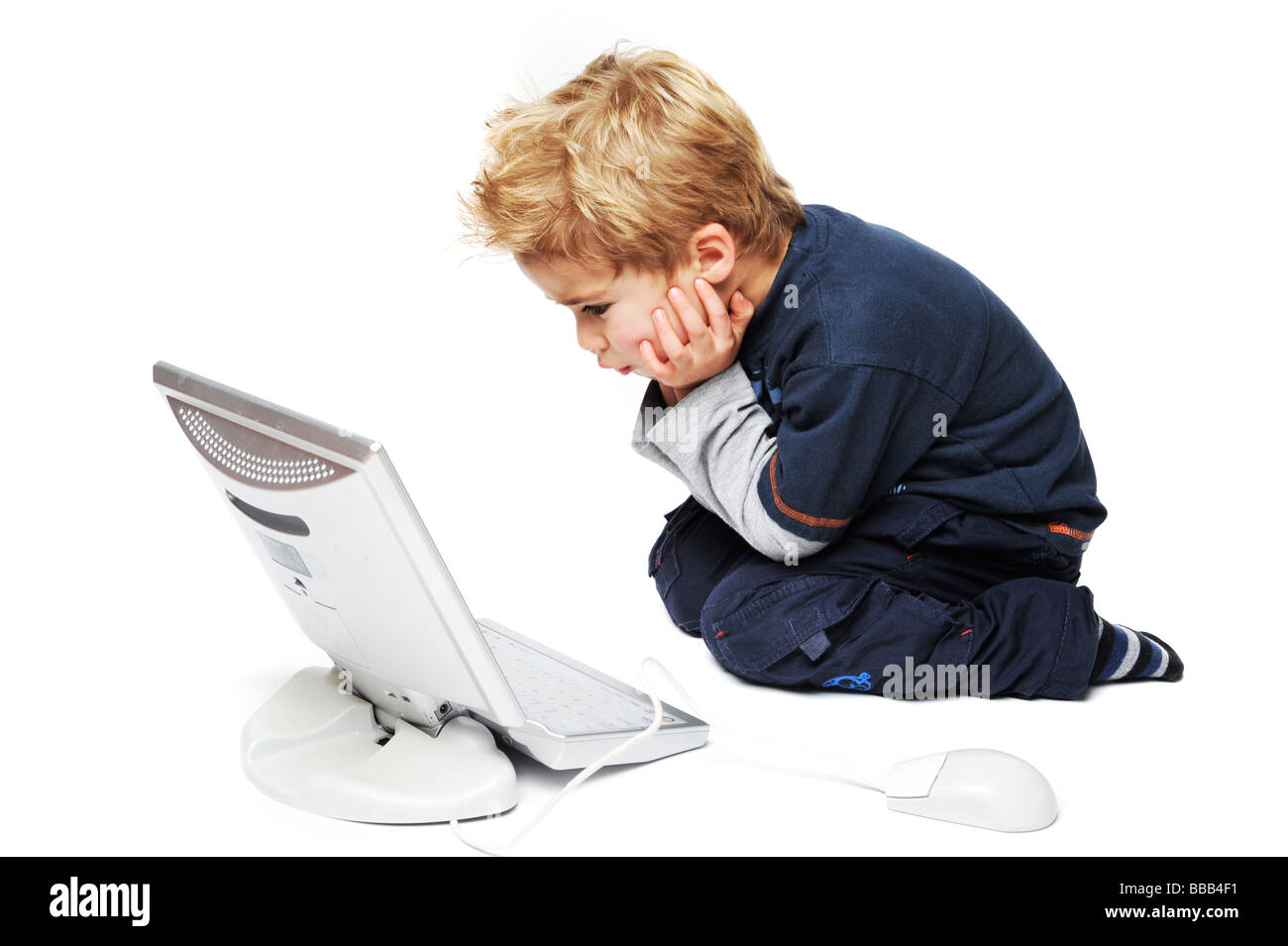 young boy looking at his computer with a problem Stock Photo - Alamy