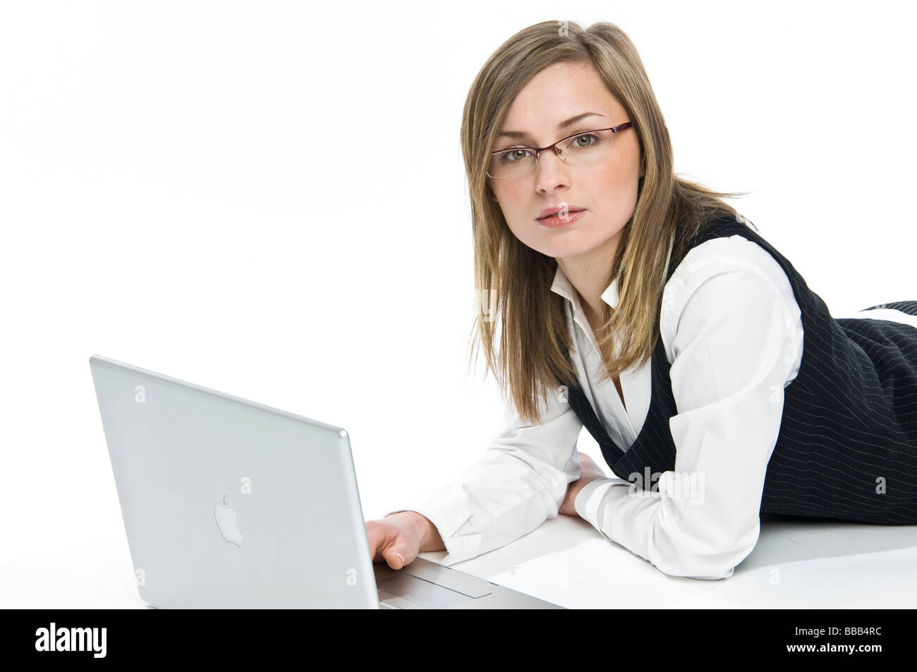 Secretary relaxing with laptop doing work Stock Photo - Alamy