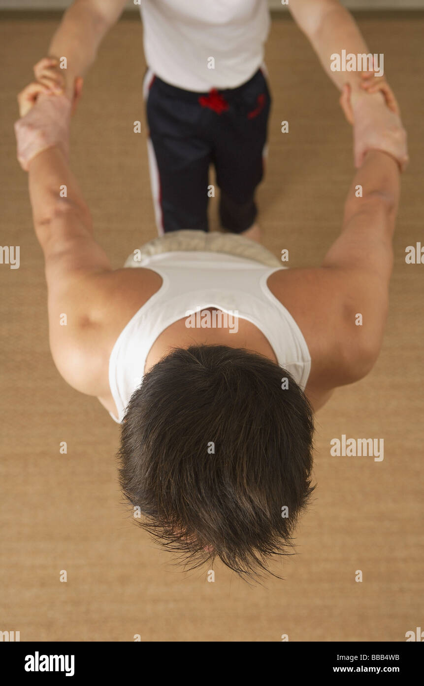 Two men doing stretching exercises Stock Photo - Alamy