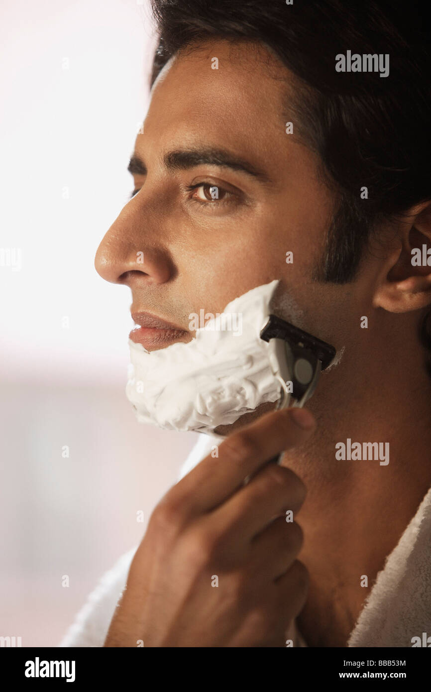 Man shaving his face Stock Photo - Alamy
