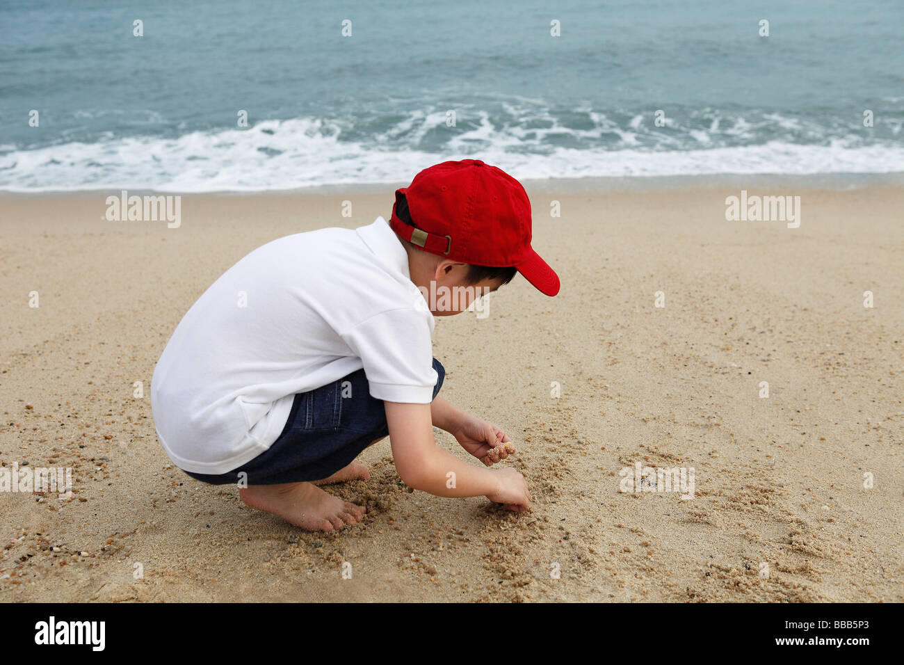 boy playing on beach Stock Photo - Alamy