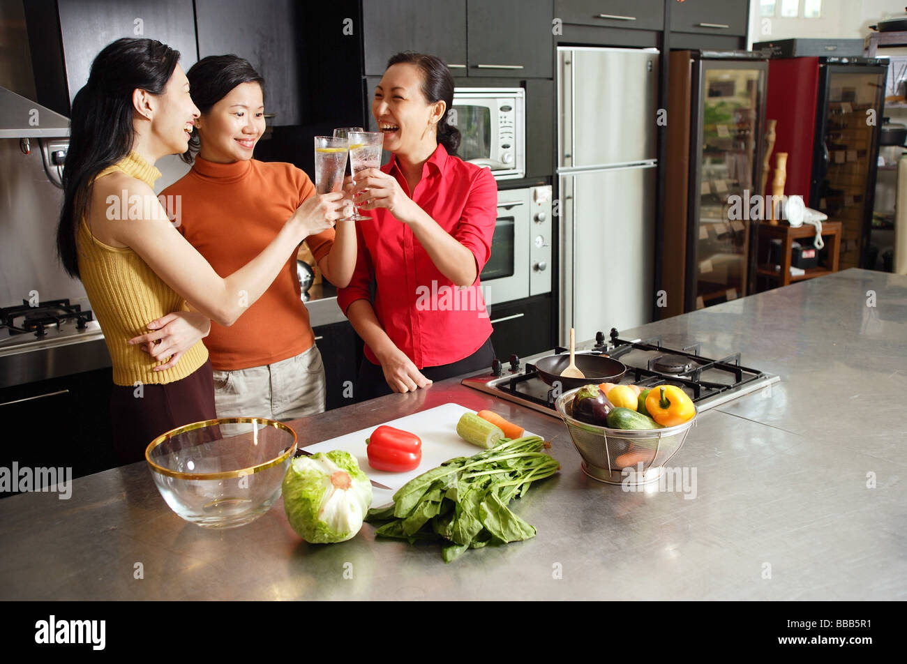 Women in kitchen, toasting Stock Photo - Alamy