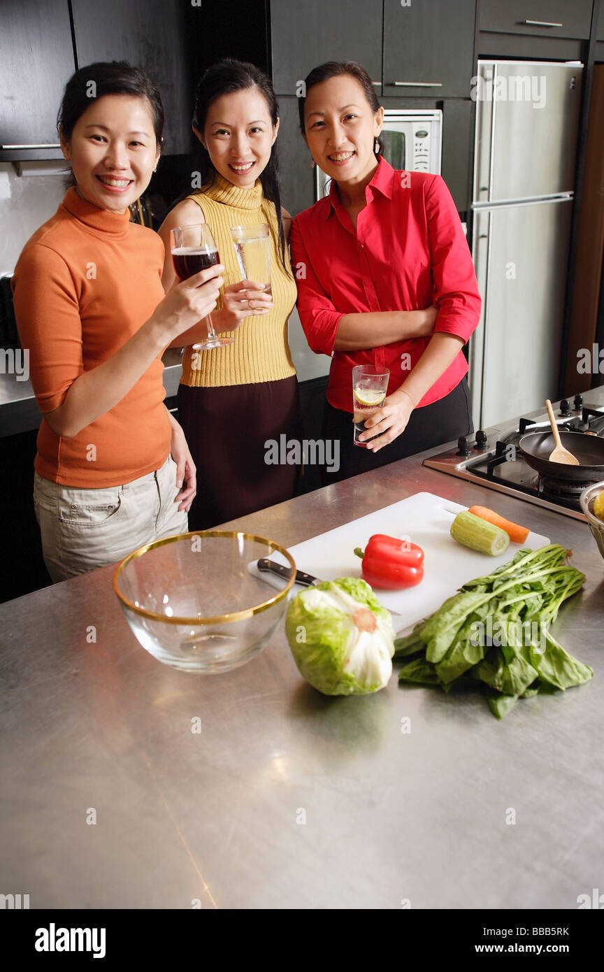 Women in kitchen, smiling at camera Stock Photo - Alamy