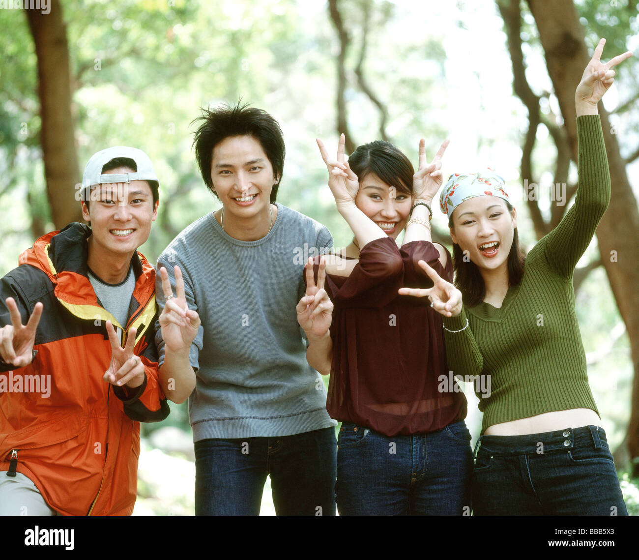 Group of friends making v-sign Stock Photo - Alamy